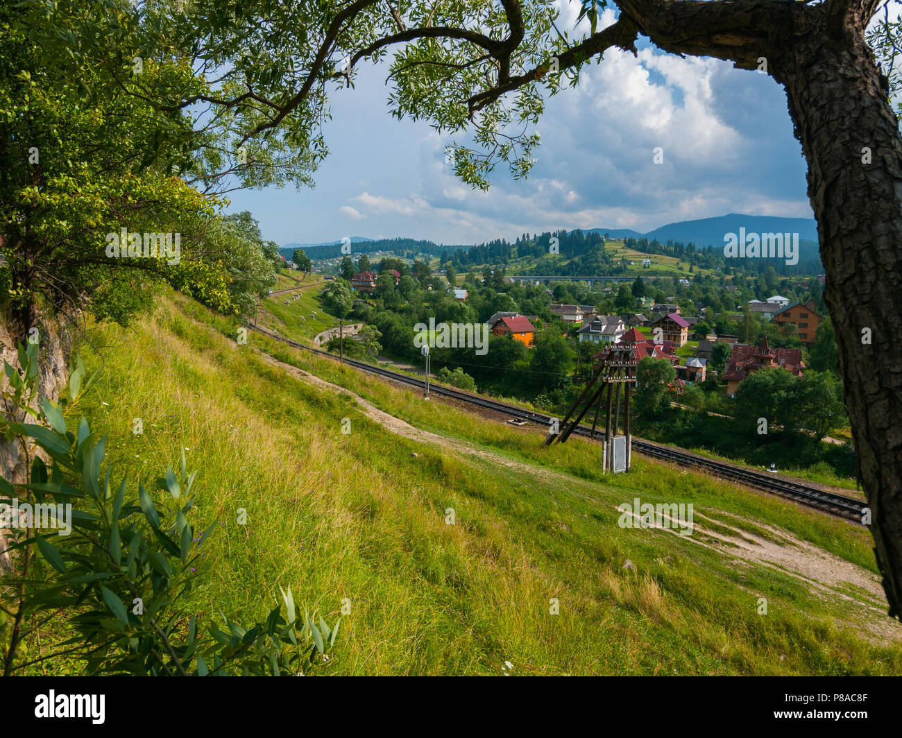 sloping green slope at the bottom of which runs around the village ...