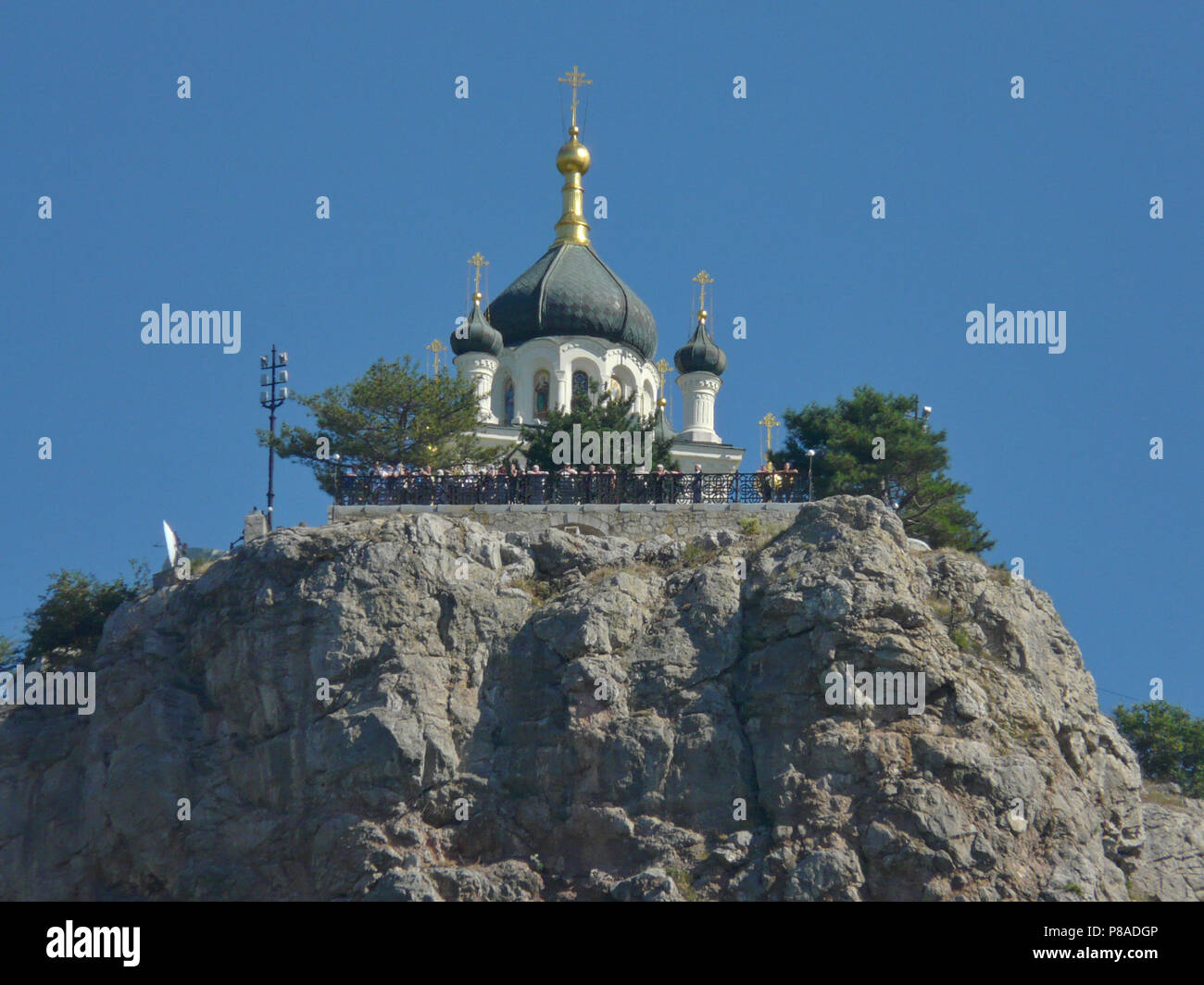 A small church with an observation deck on the top of a rocky rock on ...