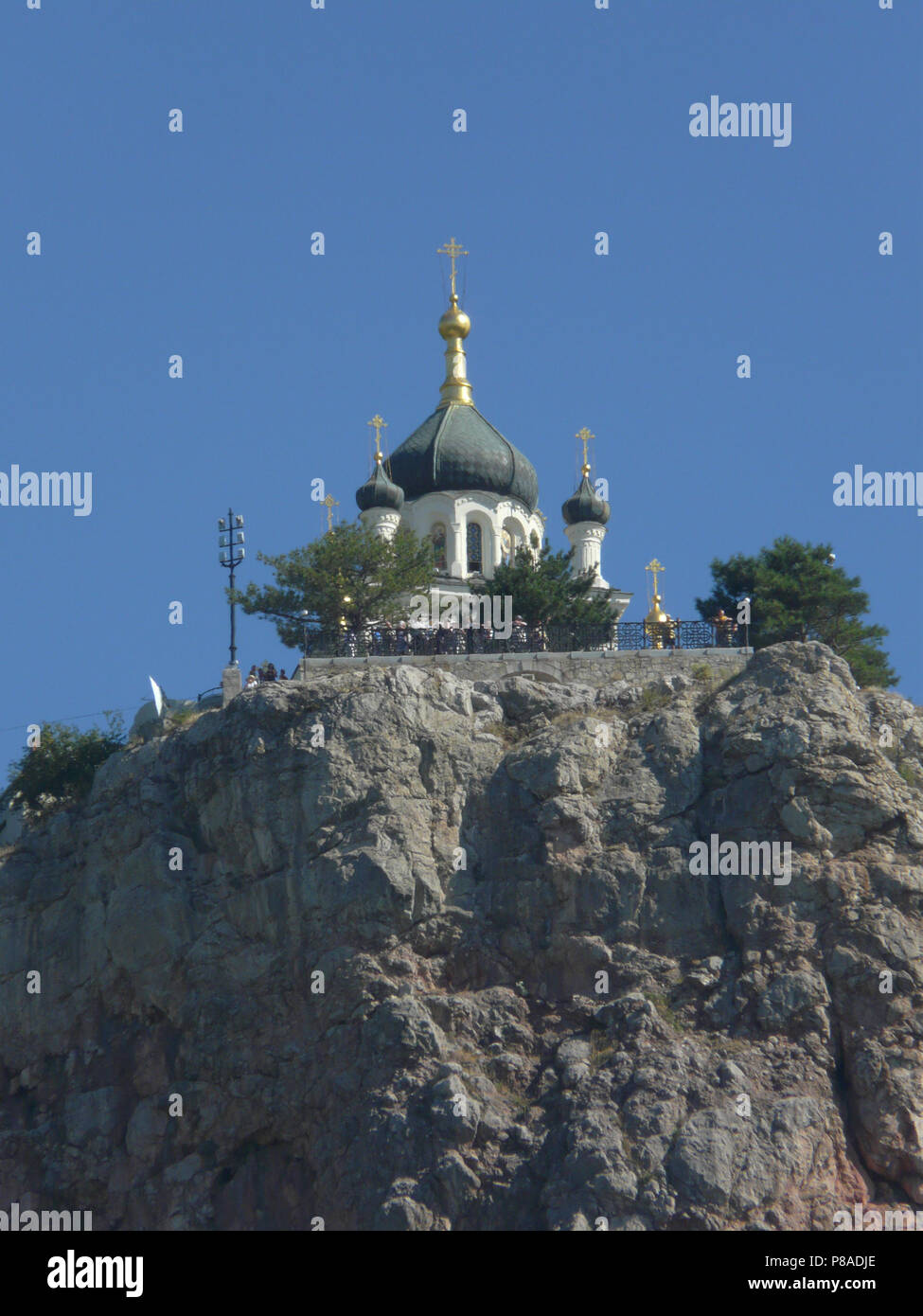 Domes with crosses of a beautiful church standing on a rock of stone ...