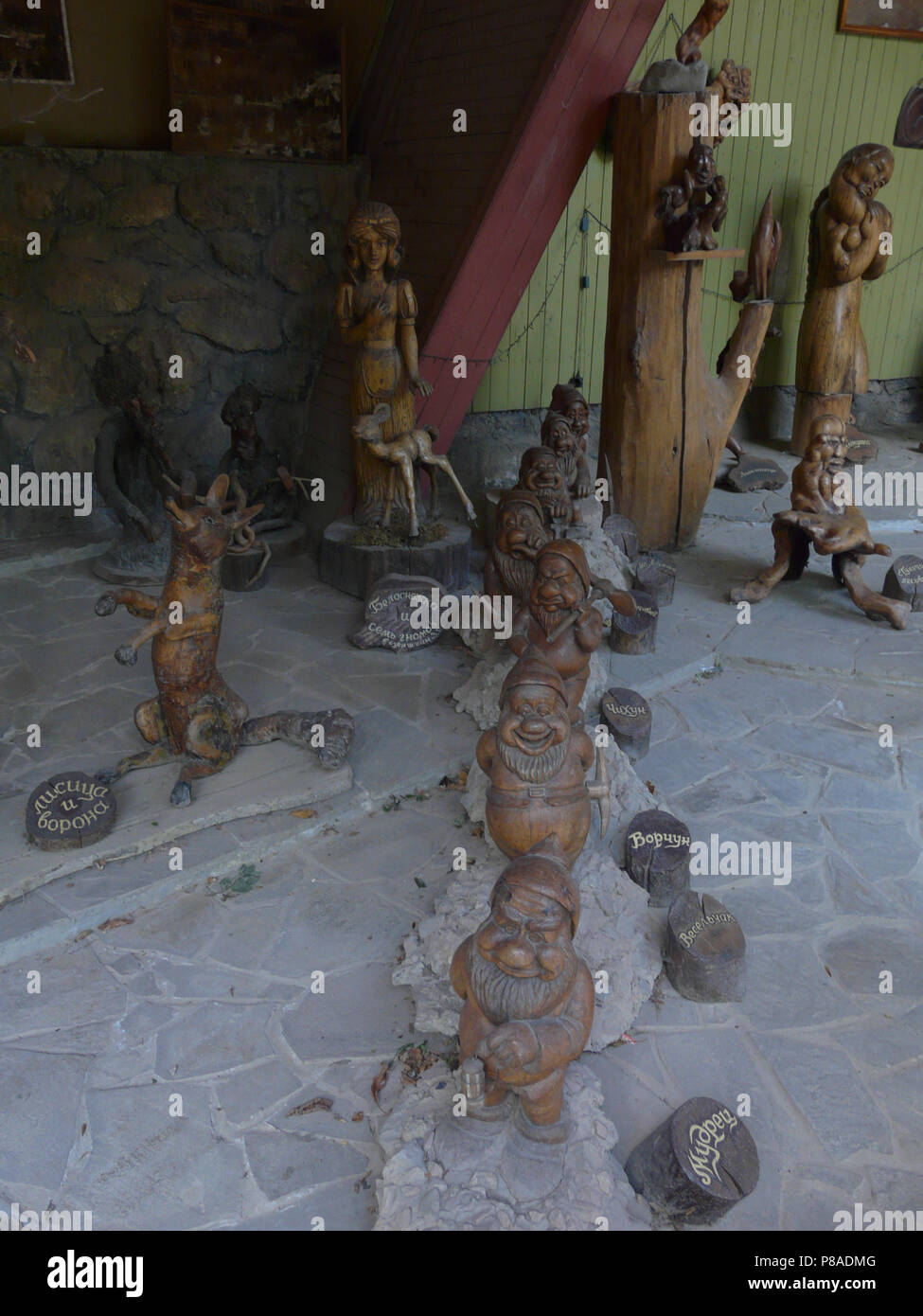 various beautiful wooden statues and seven dwarves lined up in a row ...