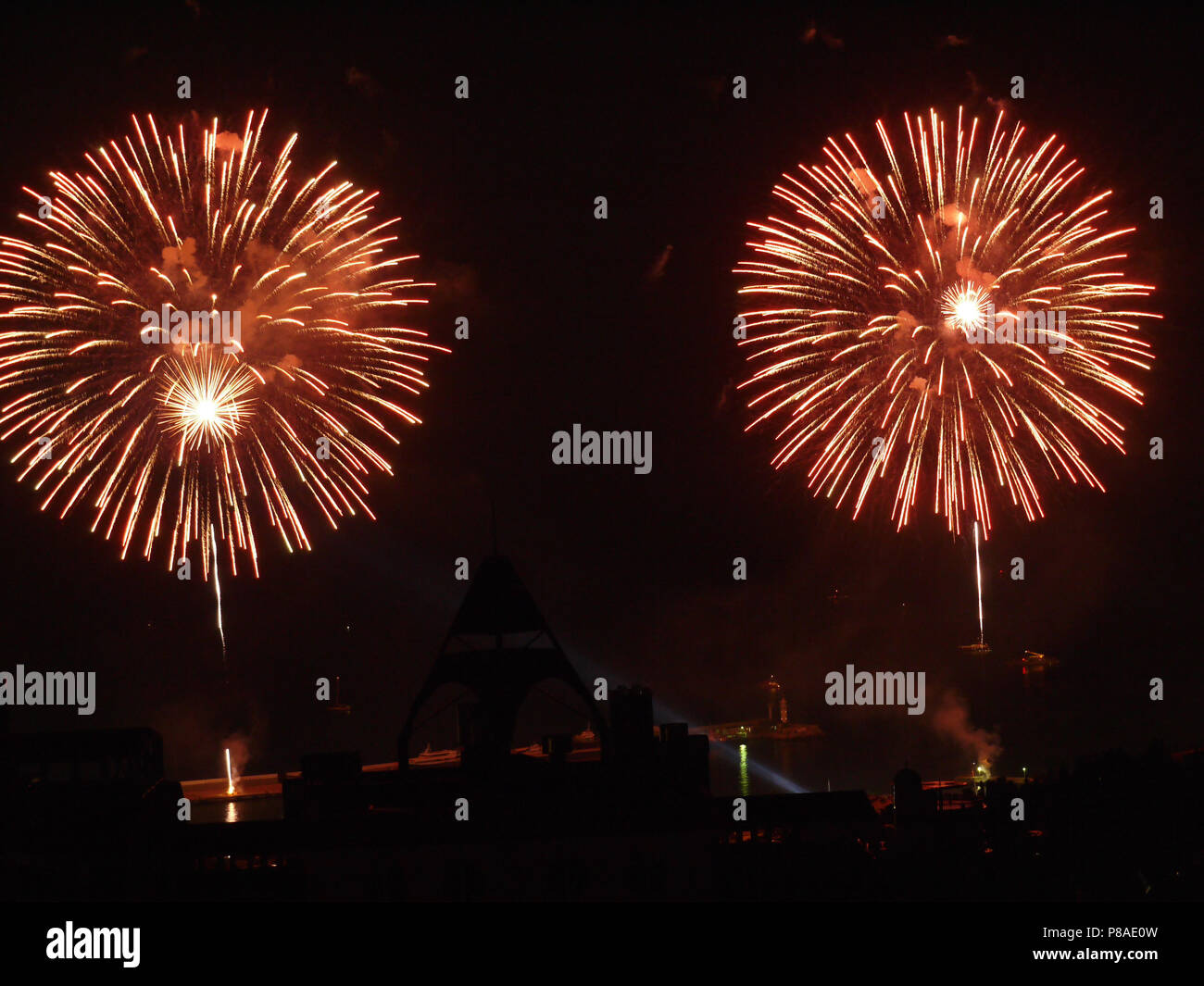 festive night fireworks scatter thousands of stars over water . For ...