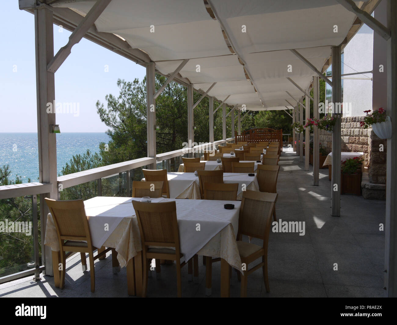 cozy tables on the terrace in a cafe with a luxurious view of the sea ...