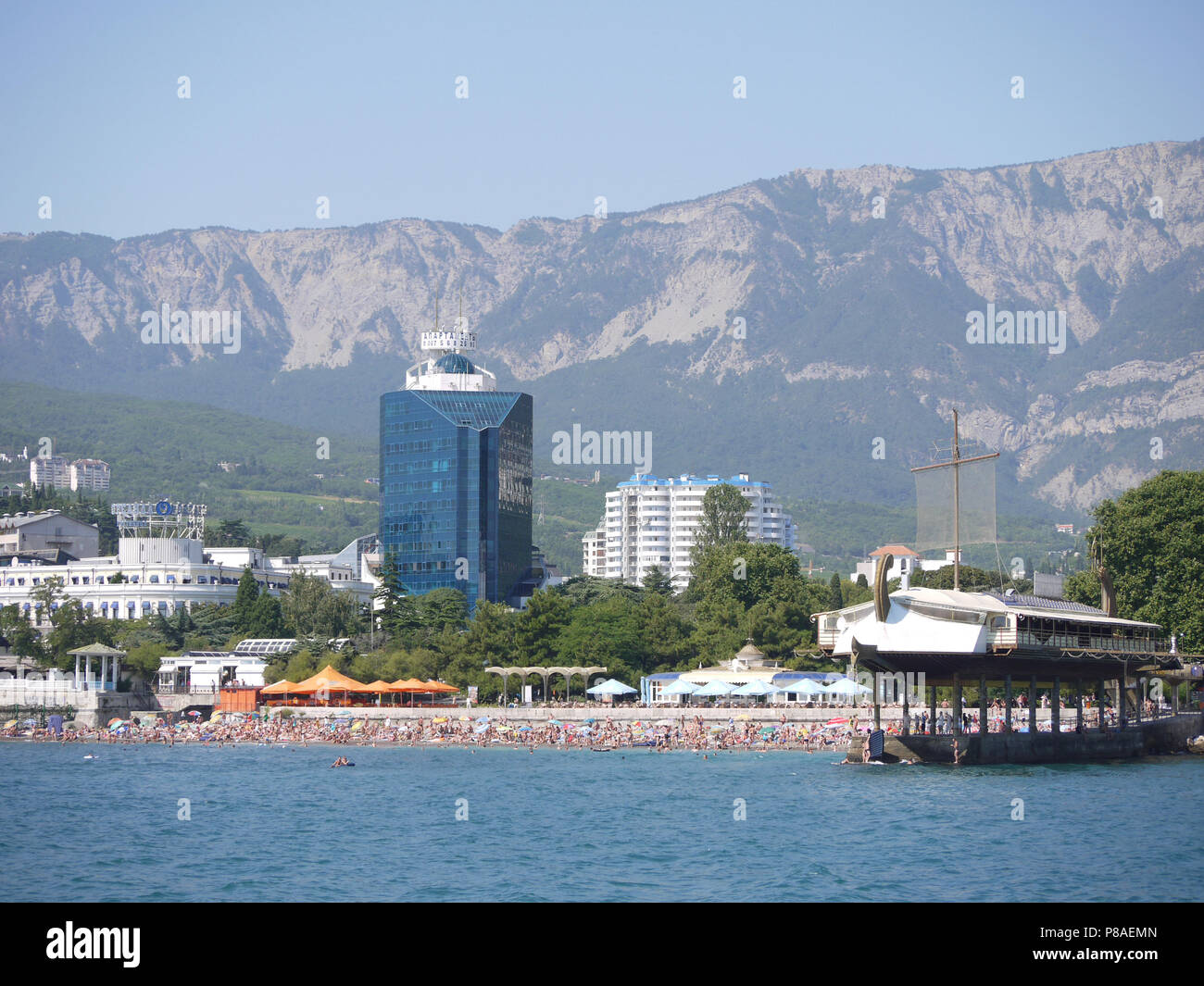 luxurious seascape waterfront scenery with hotels amid high mountains ...