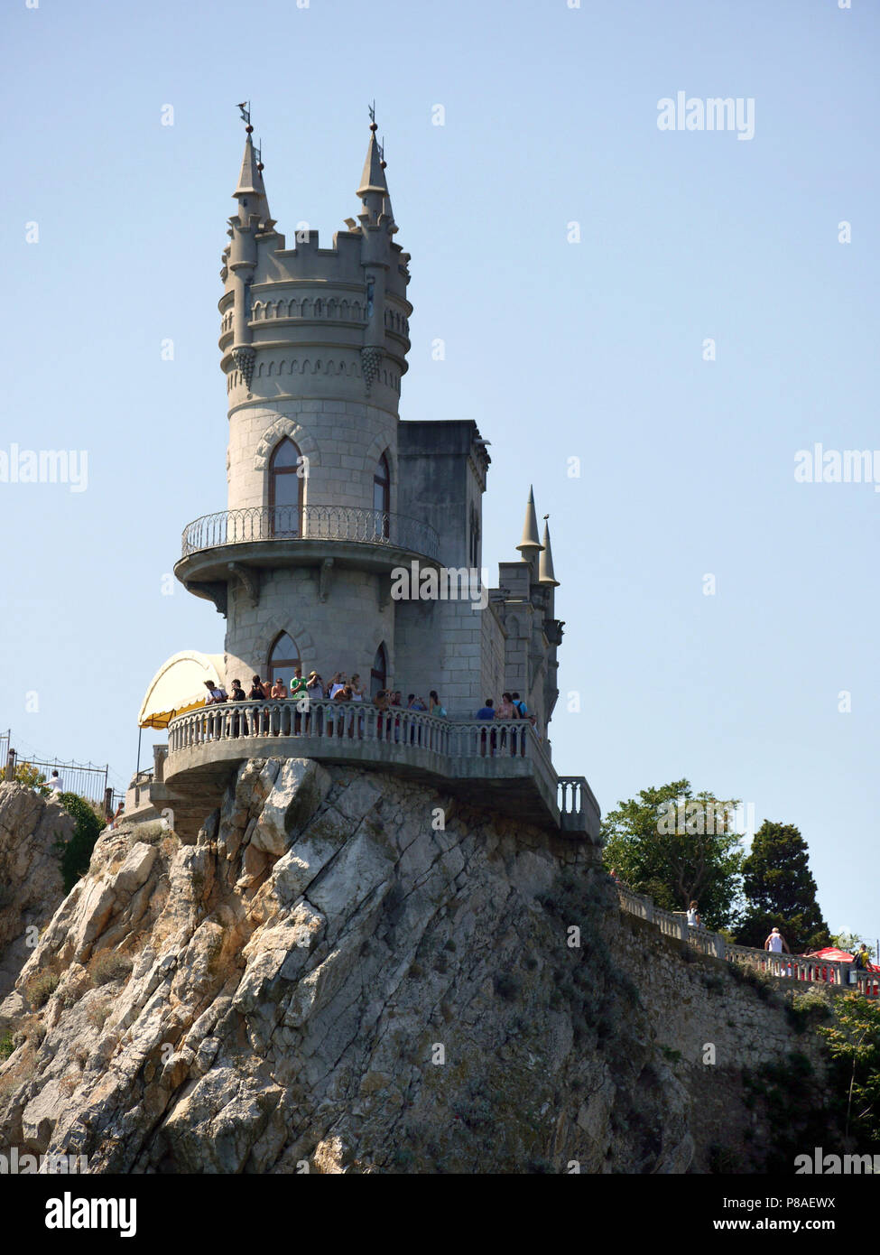 Tourists crowded on the viewing platform of the castle with turrets ...