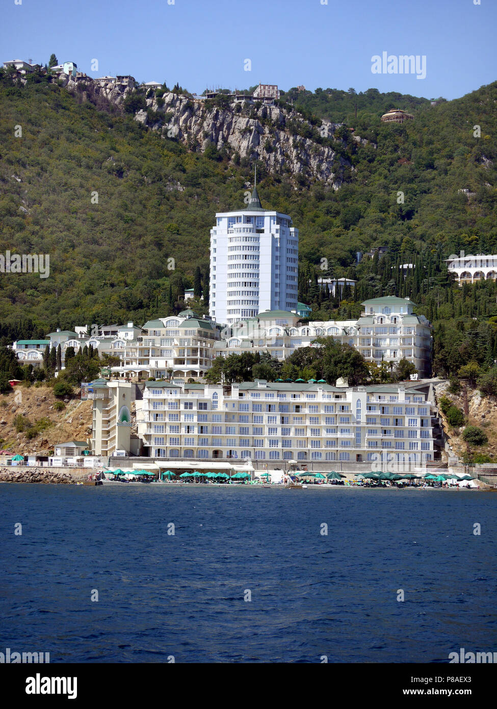 white hotels on the background of greenery on the beach with the beach ...