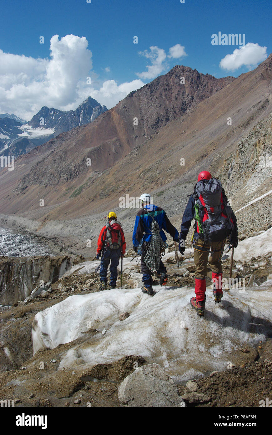 travelers hiking in snowy mountains, Russian Federation, Caucasus, July ...