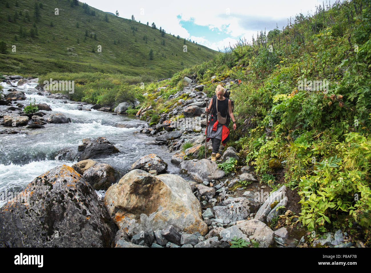 young backpacker walking near river in Altai, Russia Stock Photo - Alamy