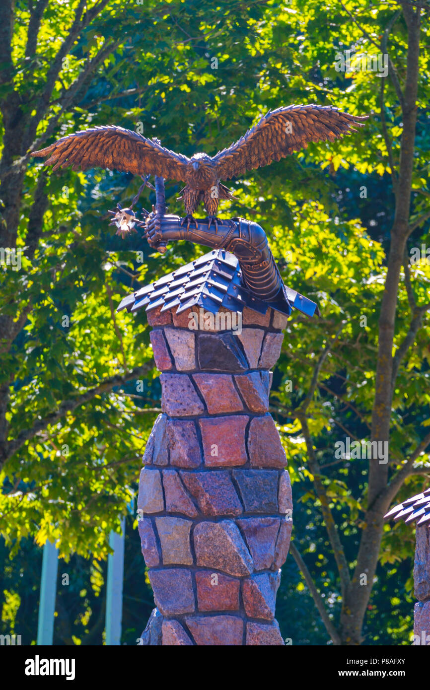 beautiful statue of a metal eagle on a stone fireplace in the house ...