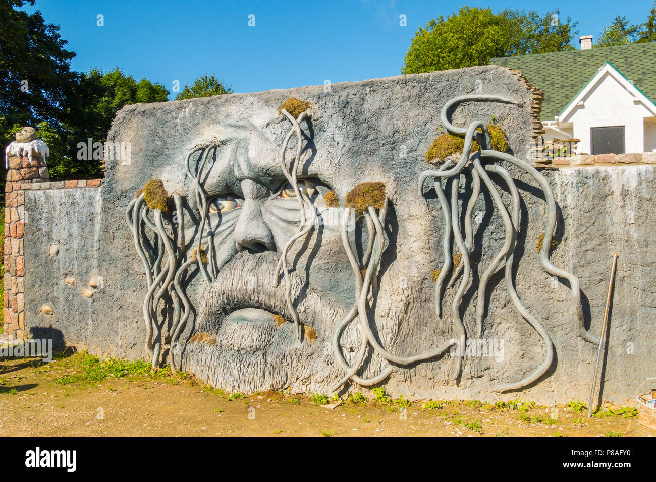 man-made wall with a picture of a human face on it executed in a very ...
