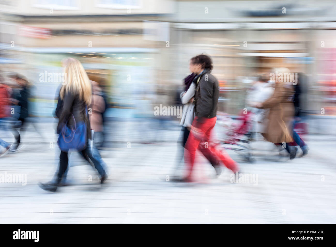 Large group of people walking in front of shop window Stock Photo - Alamy