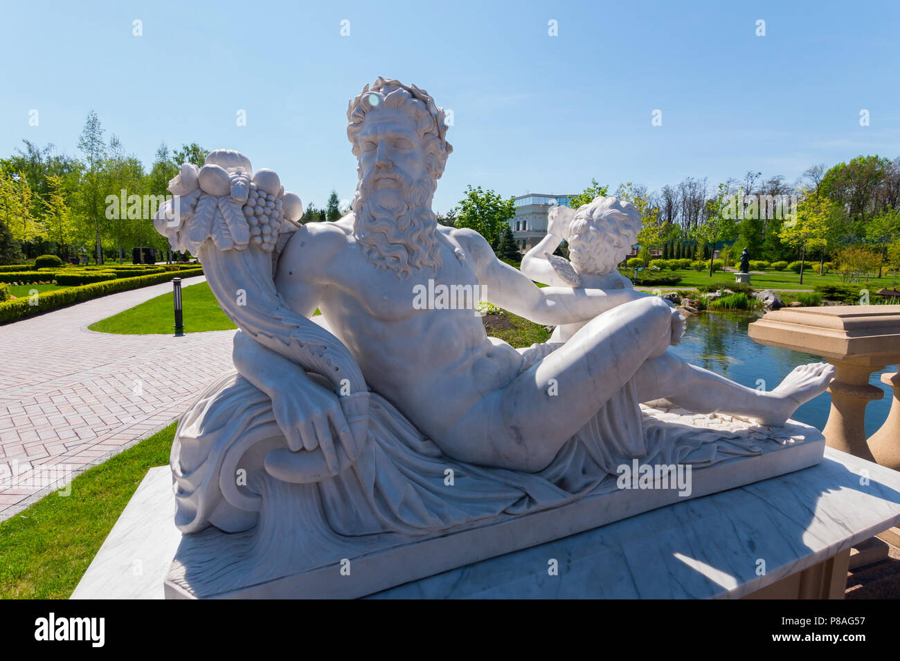 Statue of Dionysus with a bouquet of grapes on the background of a ...
