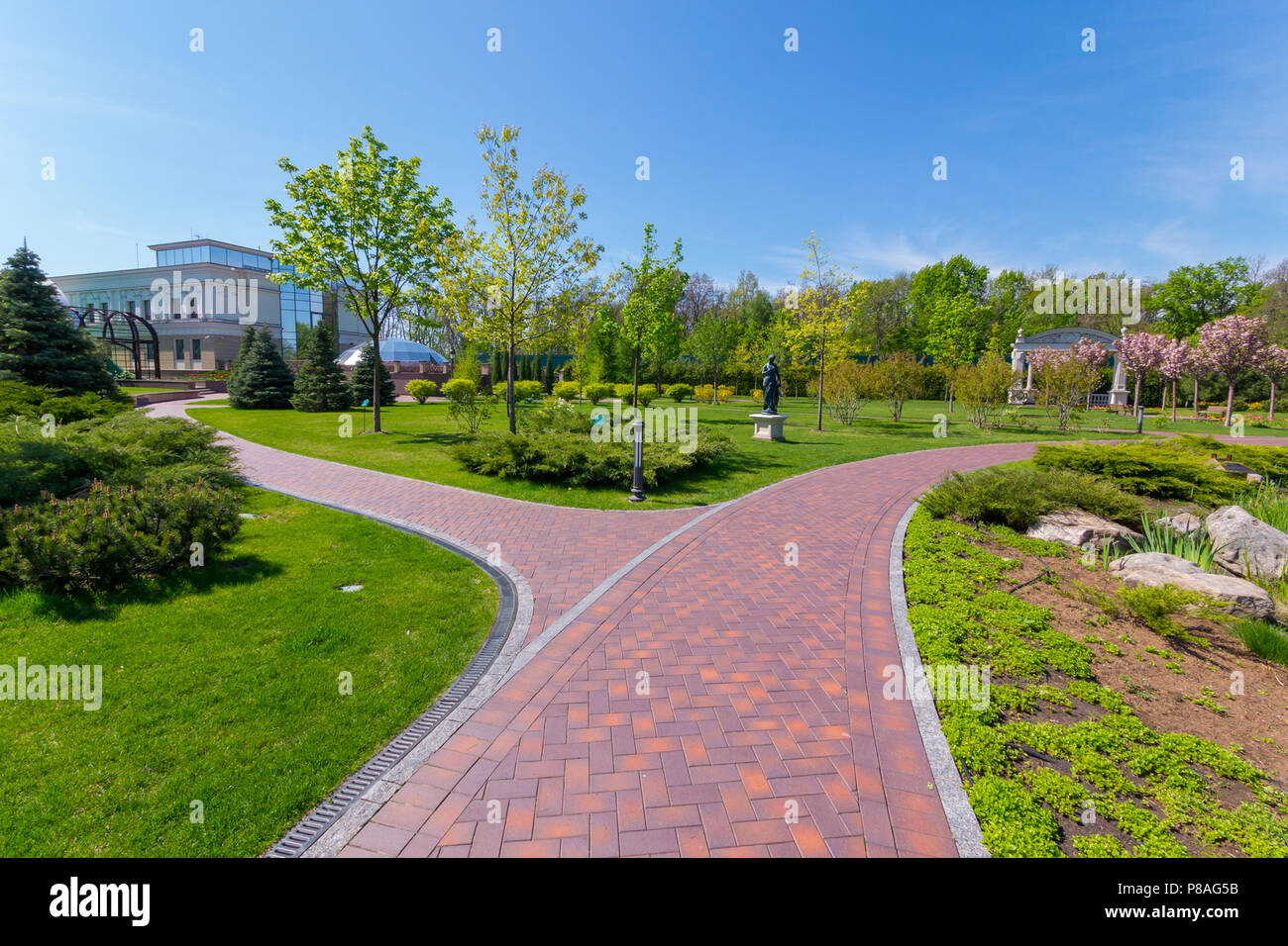 Luxurious park with trimmed lawn and stone paved paths . For your ...