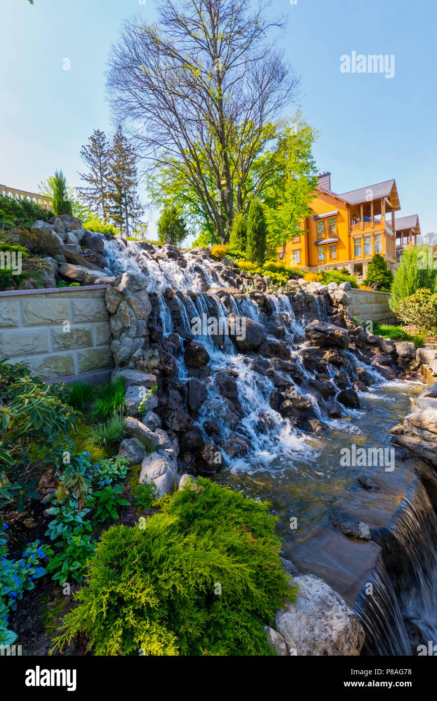 beautiful waterfall on the background of beautiful plants and a country ...