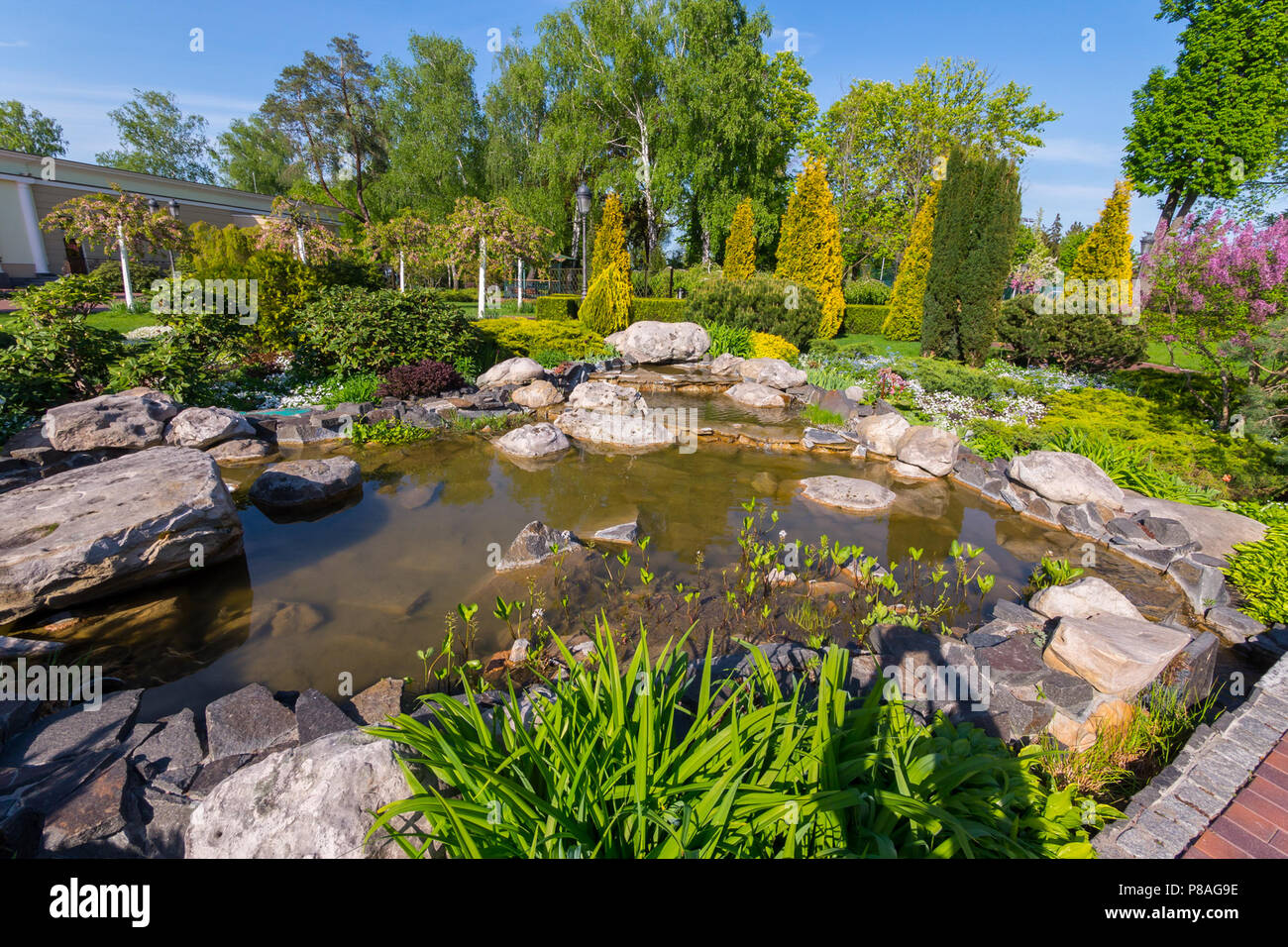small decorative pond in a park with huge stones . For your design ...