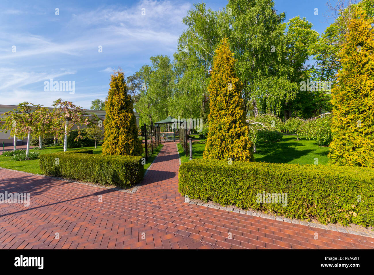 red paths in the park with beautiful landscape design near the house ...