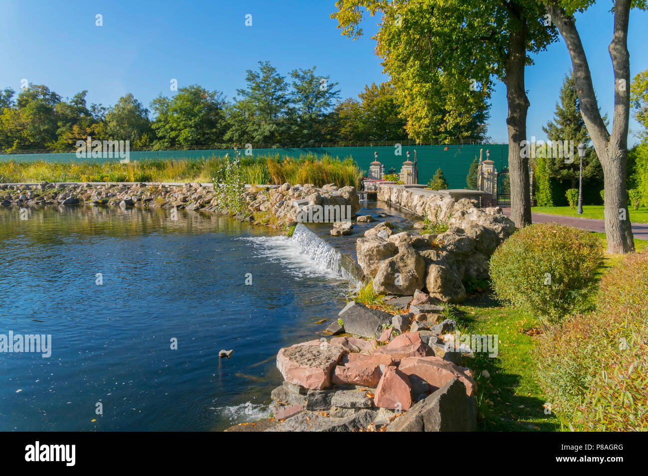Beautiful blue transparent lake with small decorative waterfalls in the ...
