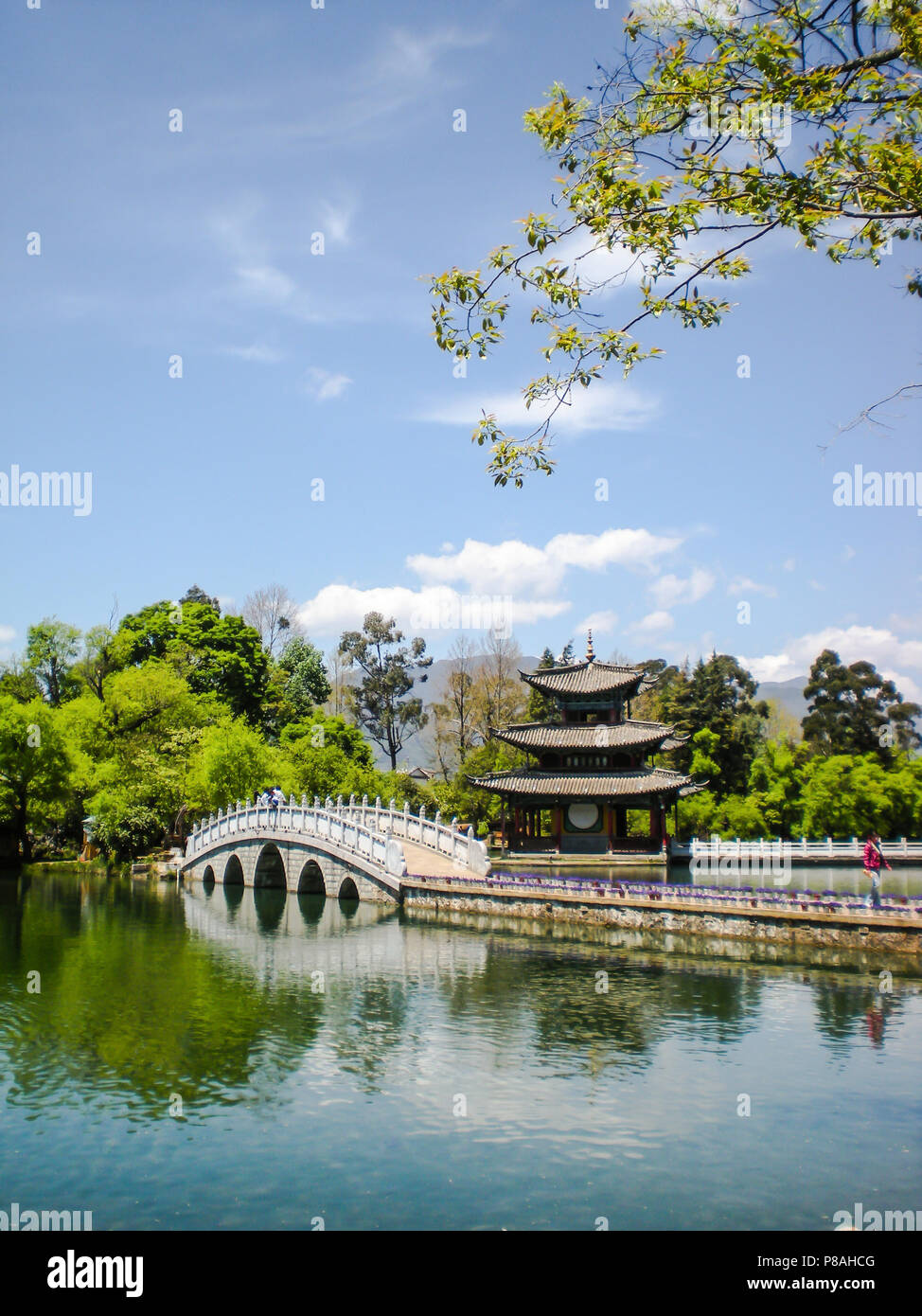 Traditional pavilion and stone bridge at the black dragon pool in ...