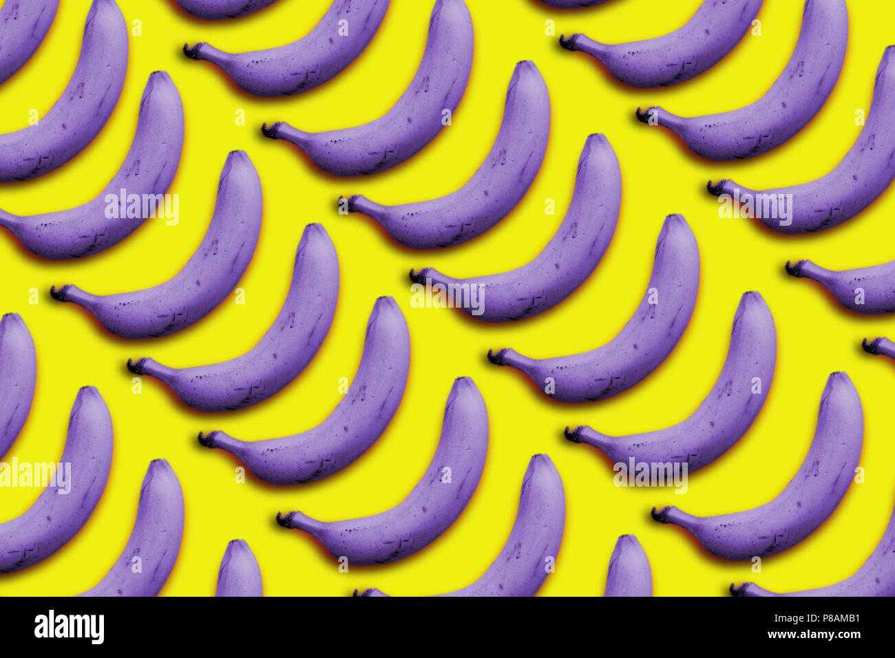 Creative idea in a surrealistic style purple bananas on a yellow ...