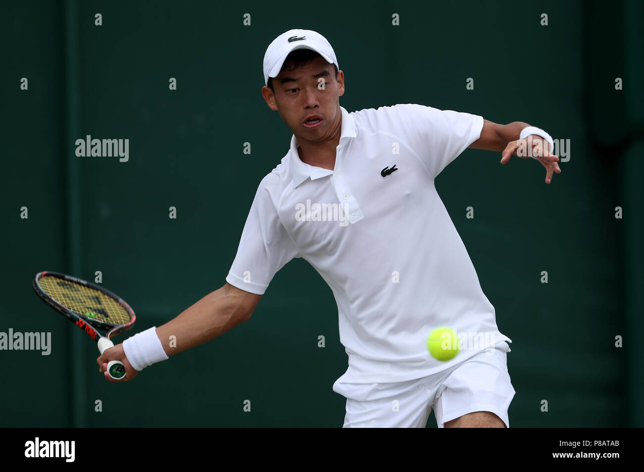 Tao Mu in action on day eight of the Wimbledon Championships at the All ...