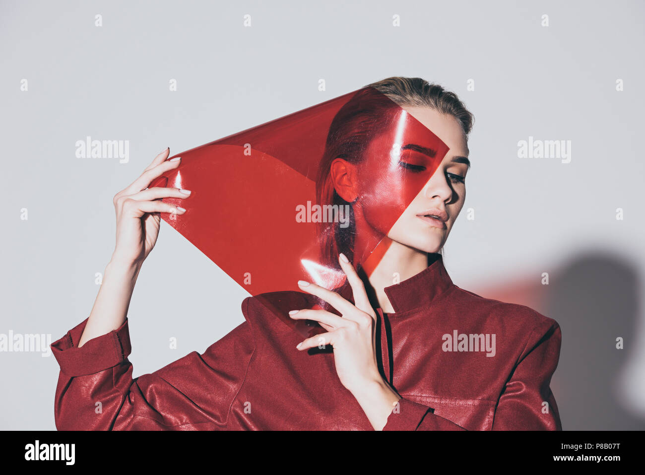 attractive fashionable girl posing with red filter, isolated on grey ...
