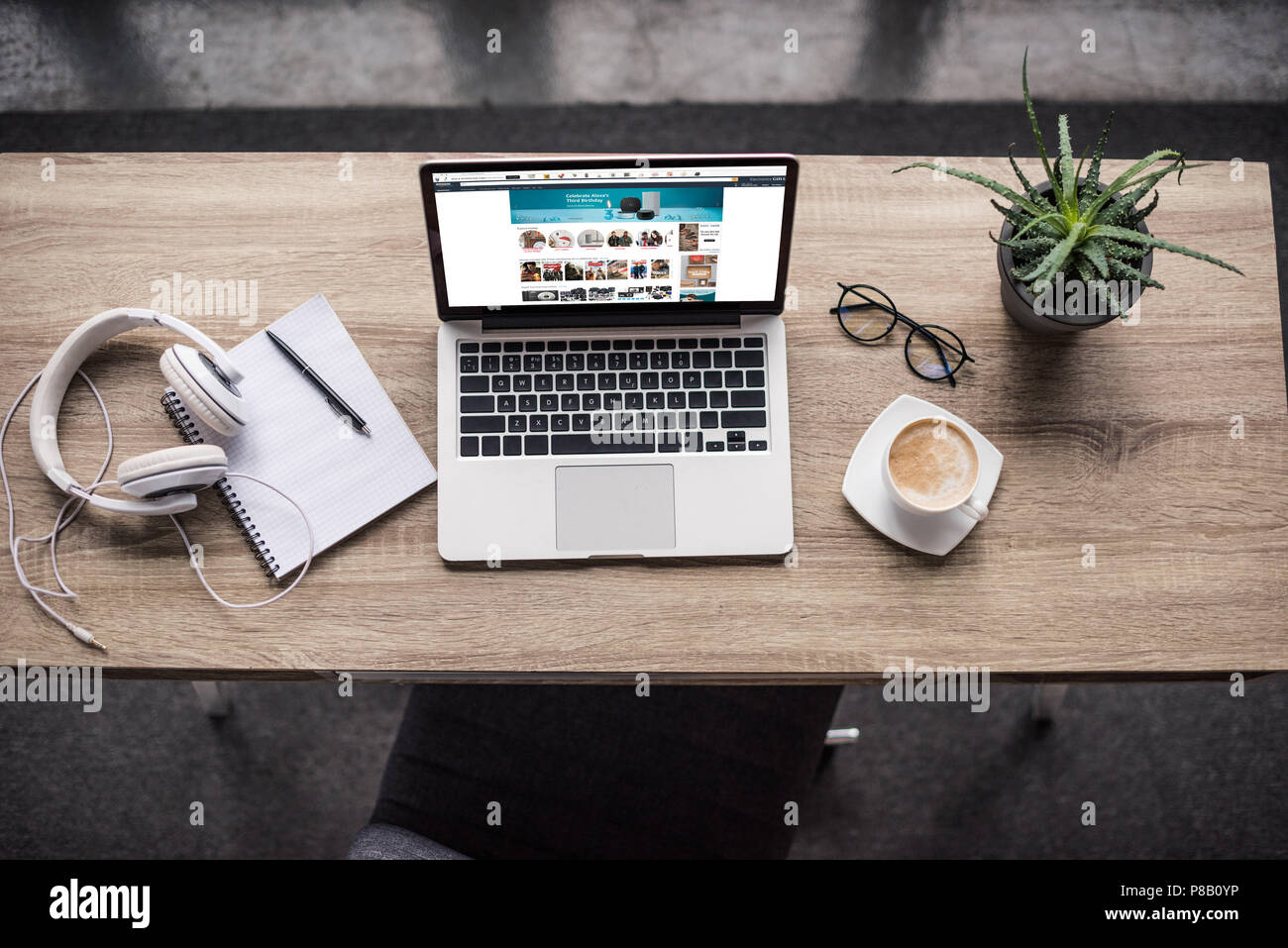 top view of laptop standing at modern workplace with amazon website on ...