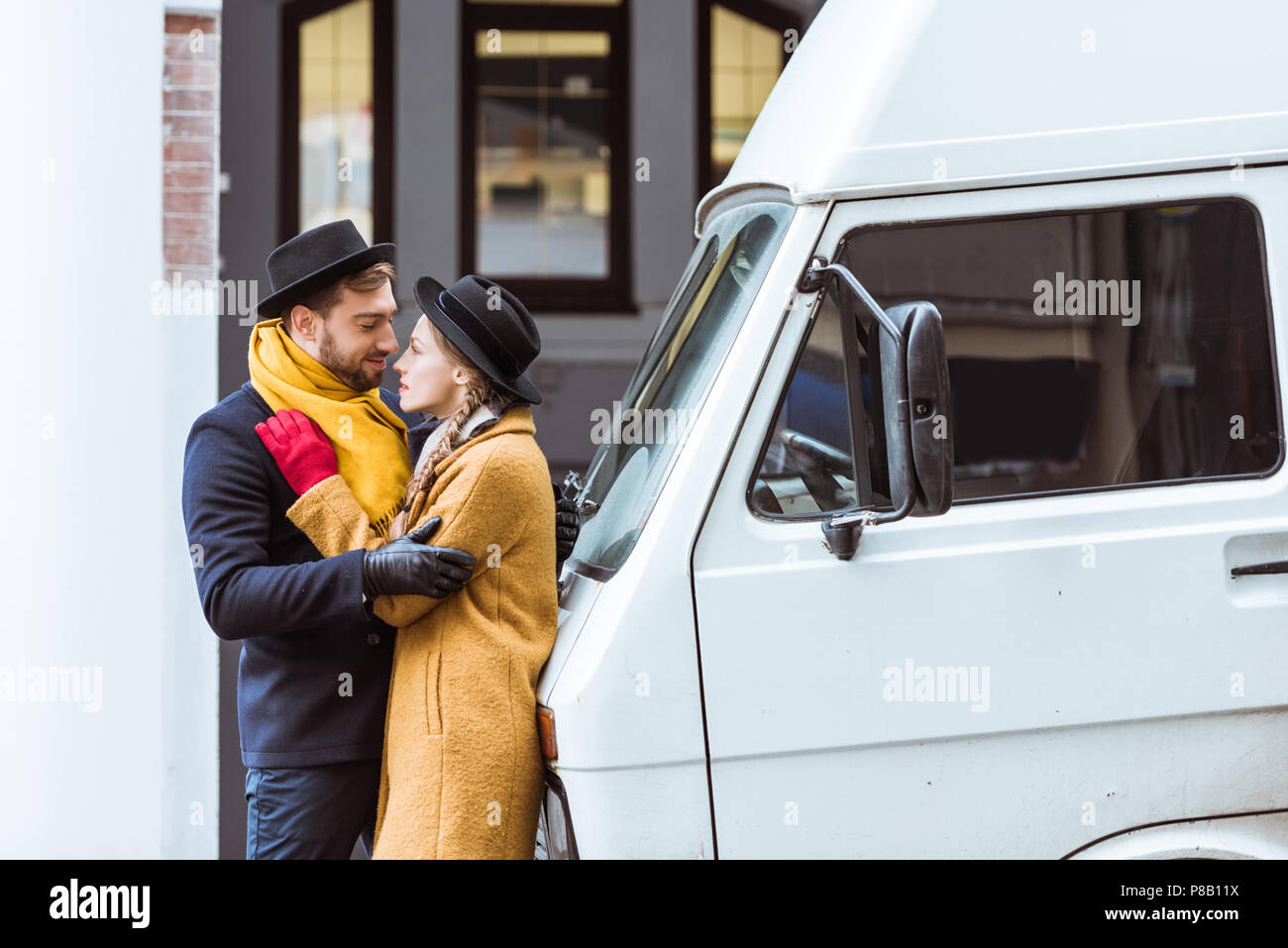 beautiful young couple hugging beside car Stock Photo - Alamy