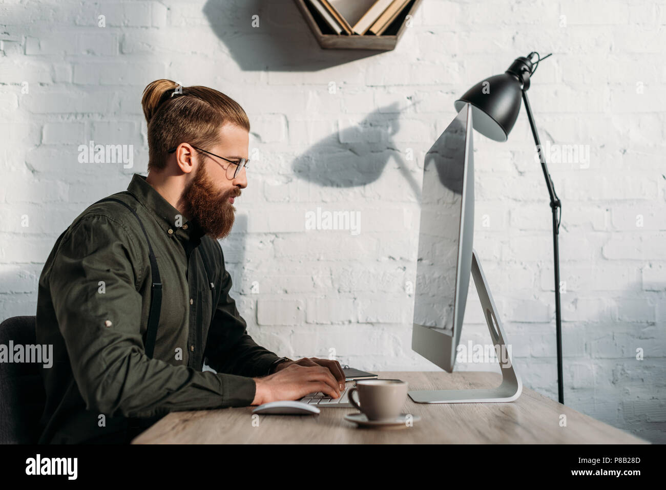 side view of handsome businessman using computer in office Stock Photo ...