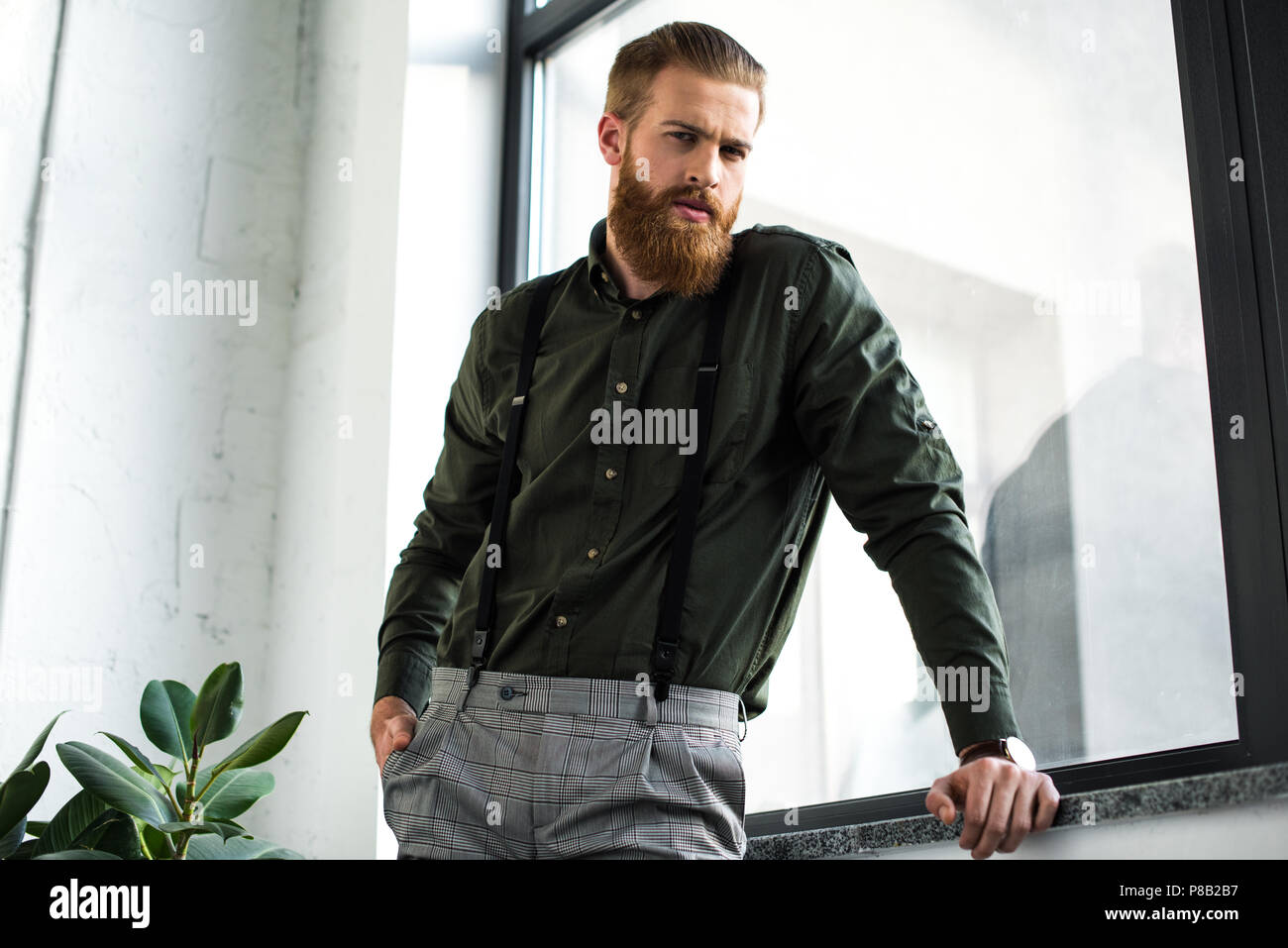 bottom view of bearded businessman standing and looking at camera Stock ...