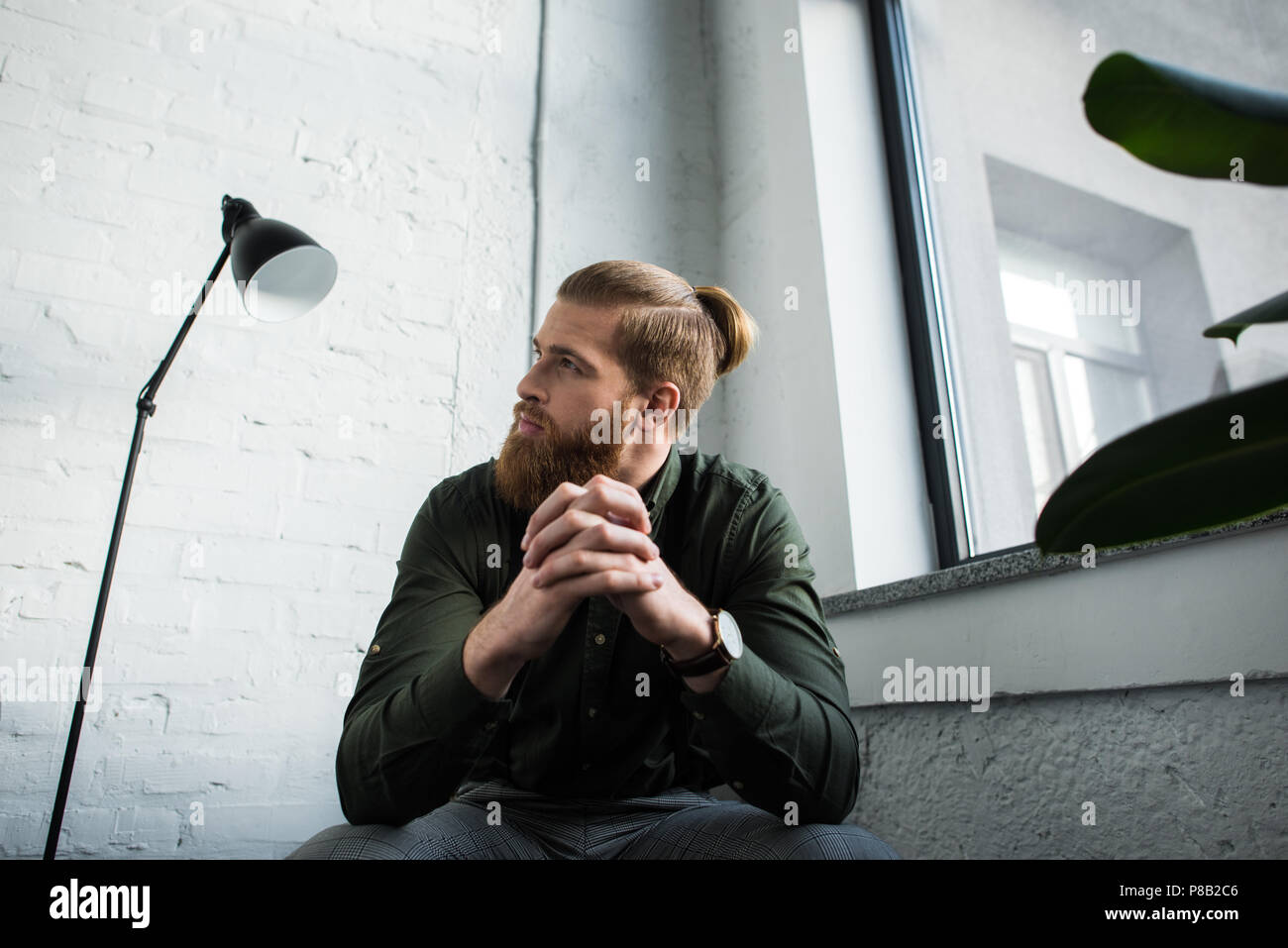 bottom view of businessman sitting and looking up Stock Photo - Alamy