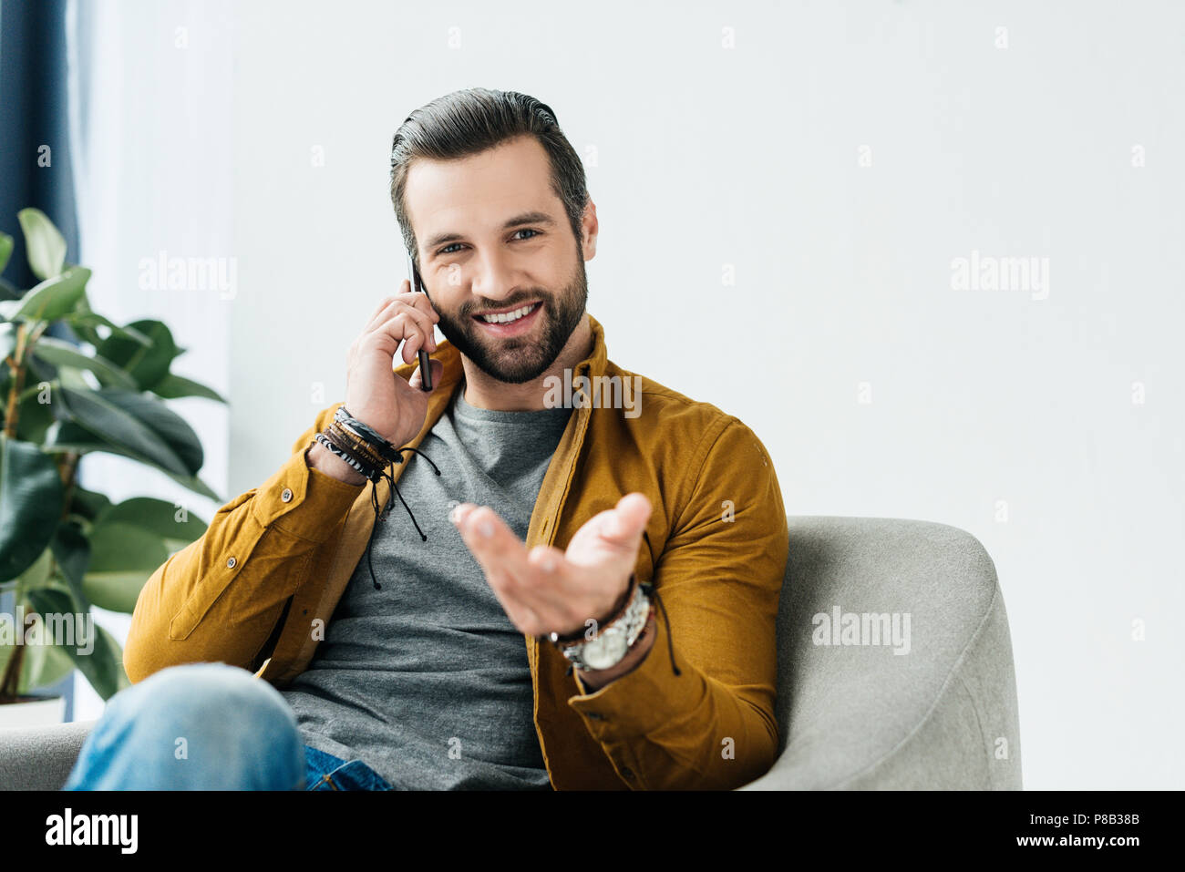 Handsome smiling man talking hi-res stock photography and images - Alamy