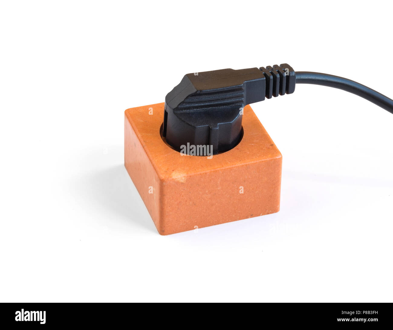 Electric plug inserted into an electrical outlet on a white background ...