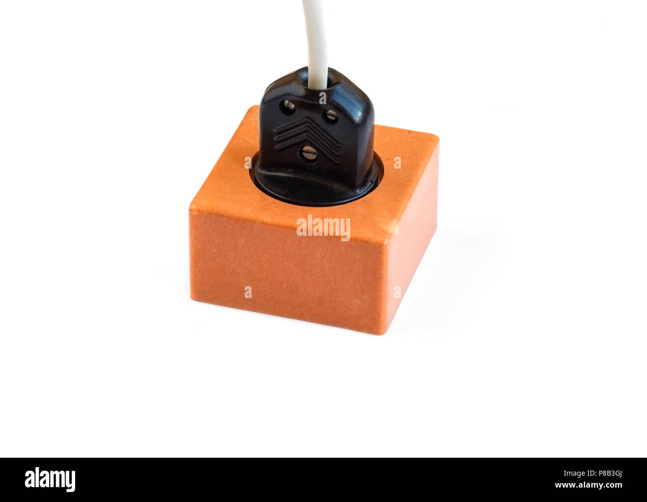 Electric plug inserted into an electrical outlet, white background ...