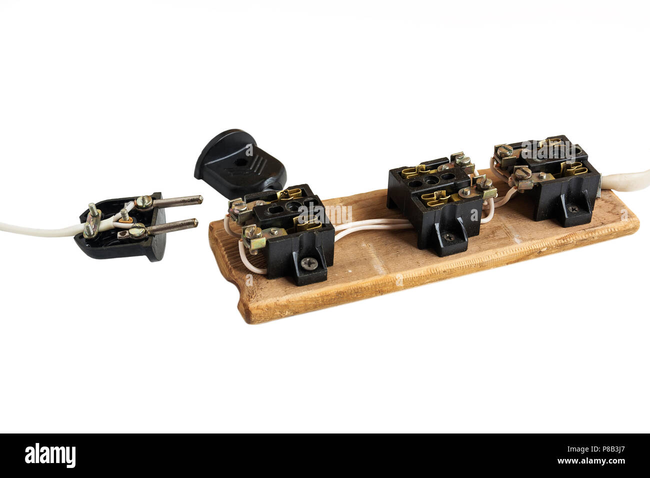 On a white background a disassembled power outlet and a disassembled ...