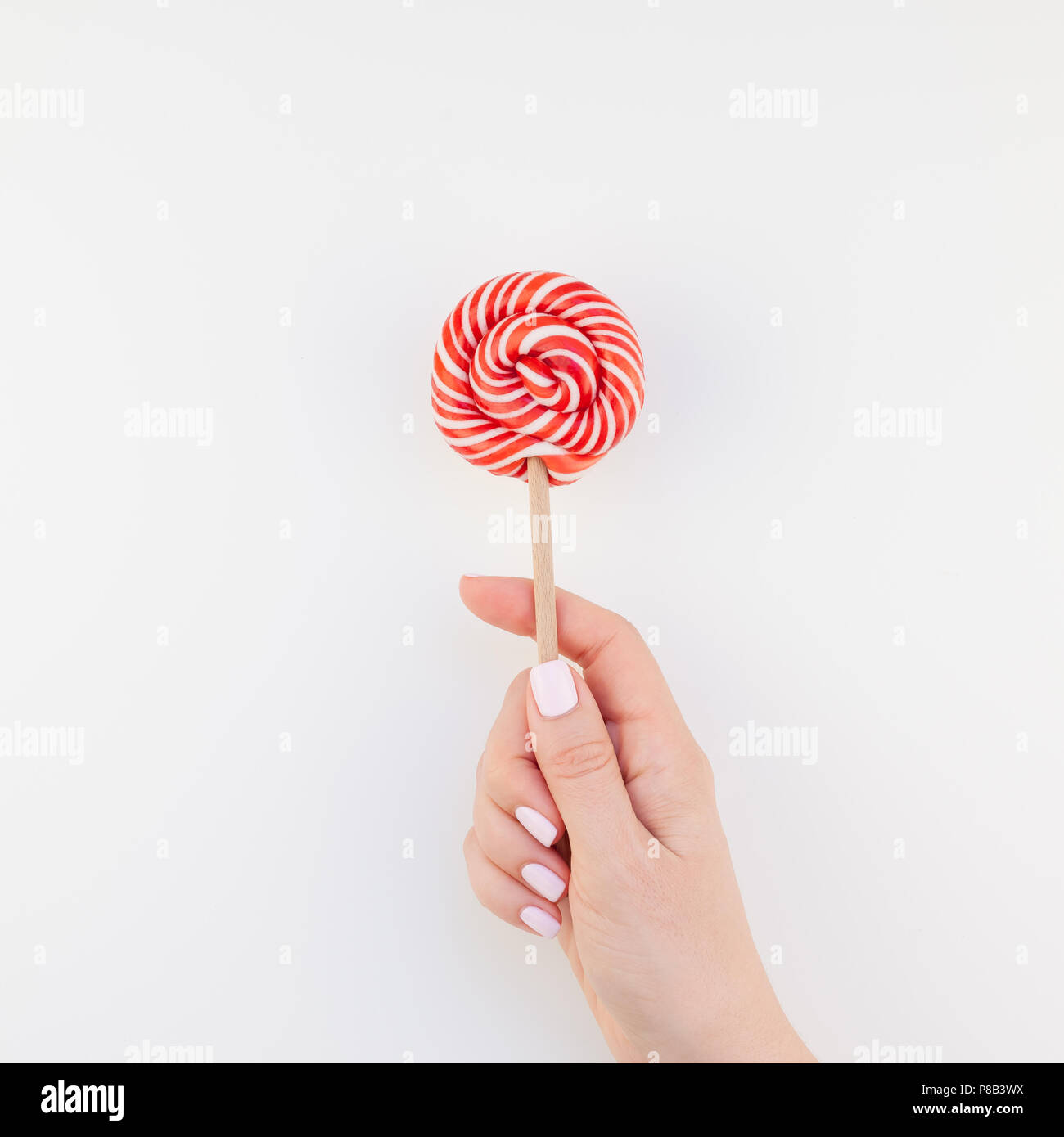 Hand holding lollipop hi-res stock photography and images - Alamy