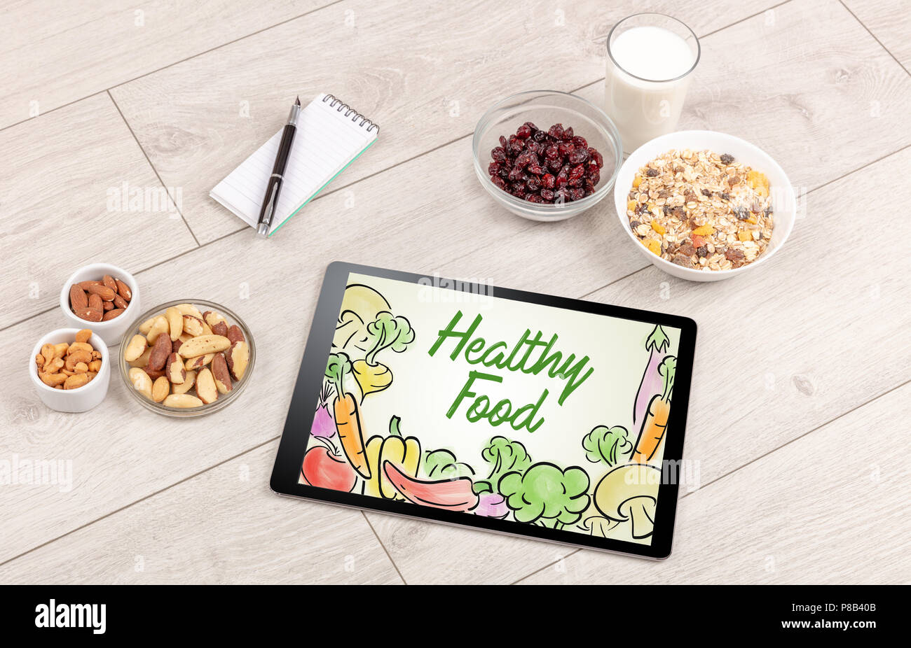 Healthy food composition with tablet Stock Photo - Alamy
