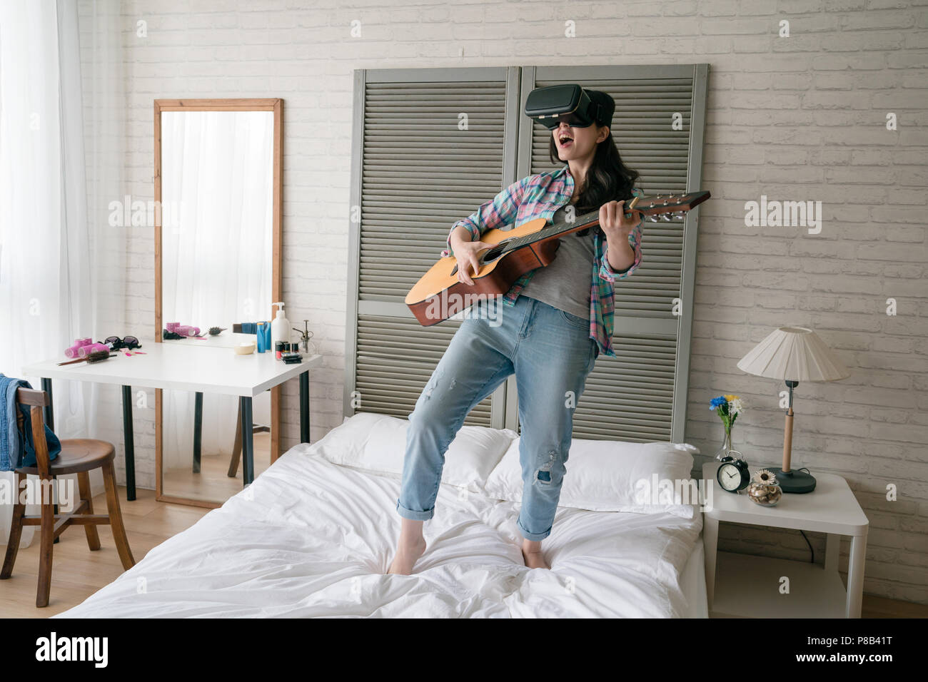 Female modern Asian woman leaning her body back and holding her wooden ...
