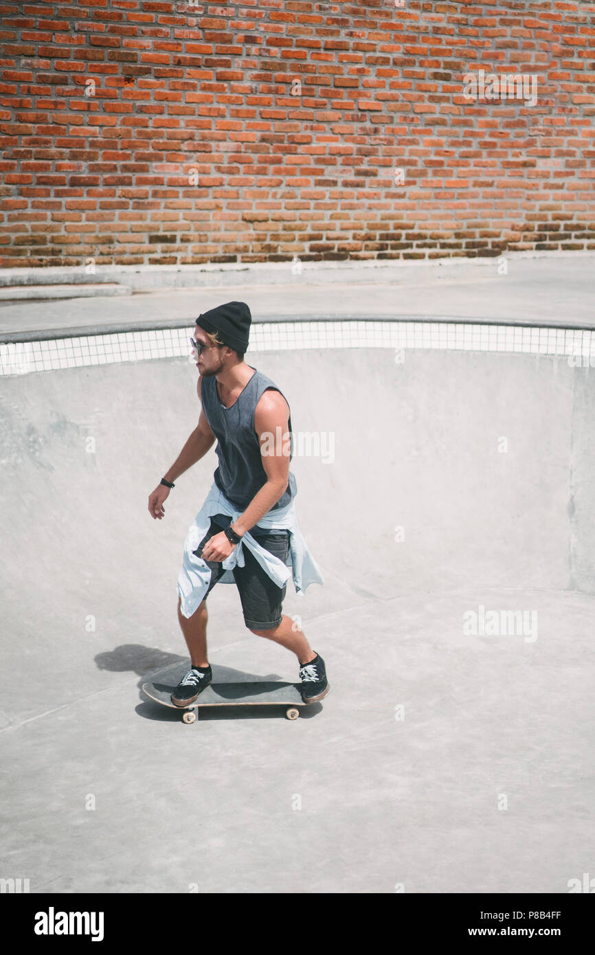 handsome sportive man skating at skatepark Stock Photo - Alamy
