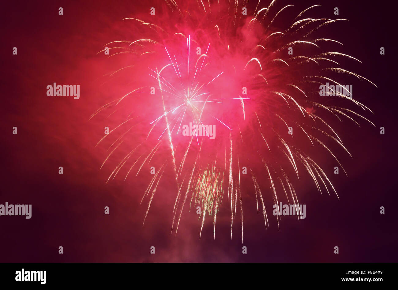 red fireworks display in night skiy with red smoke Stock Photo - Alamy