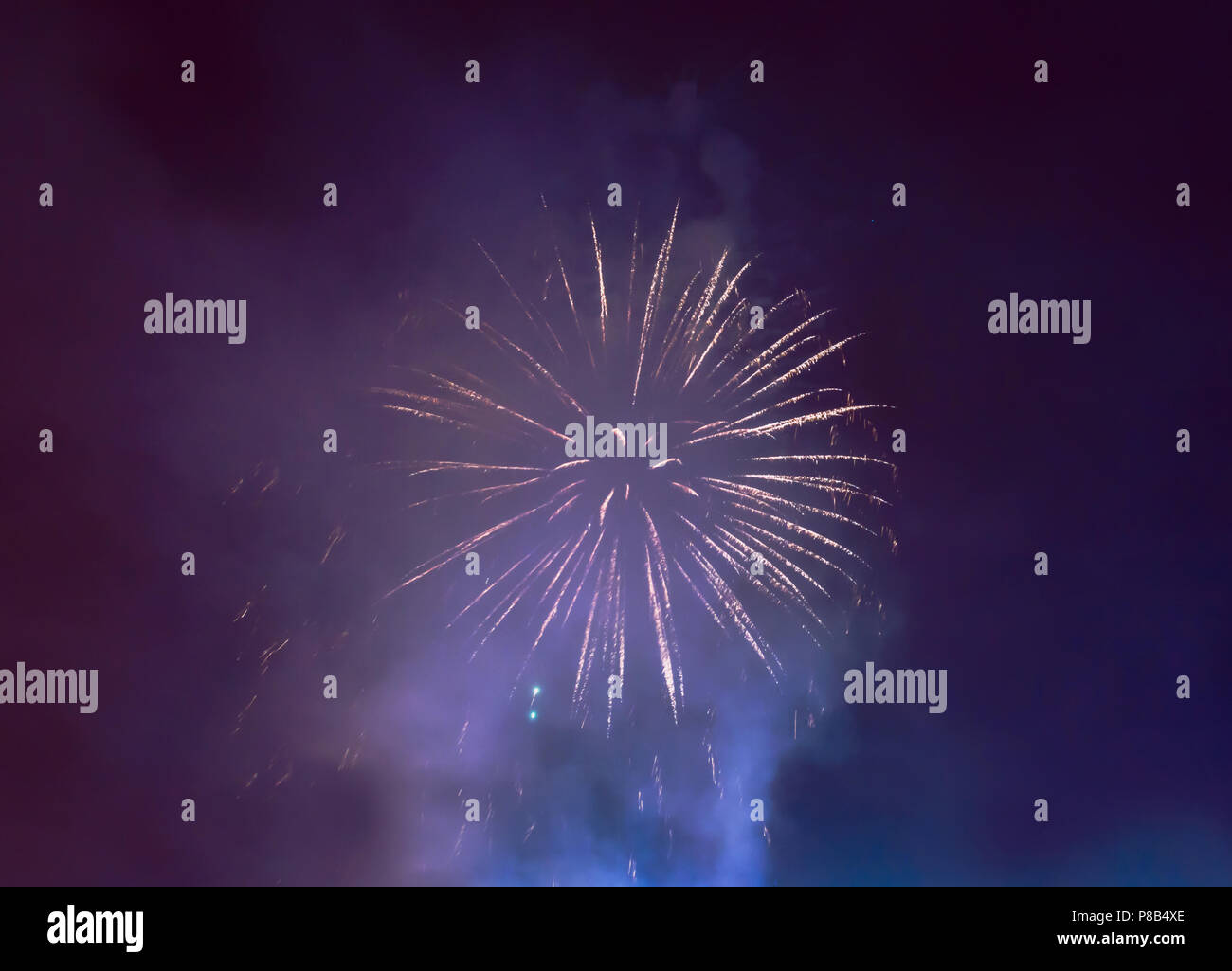 blue smoke and white fireworks in night sky to celebrate event Stock ...