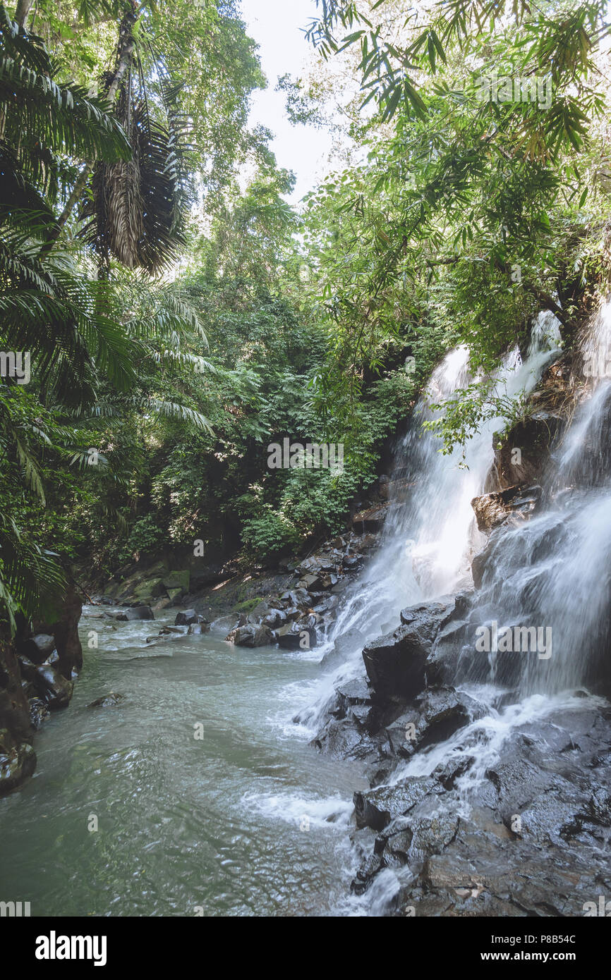 scenic view of beautiful Kanto Lampo Waterfall, green plants and rocks ...