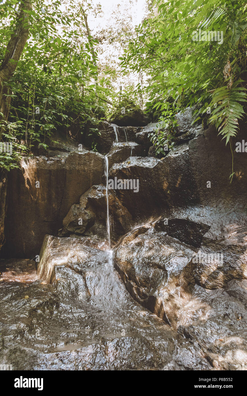 scenic view of beautiful Kanto Lampo Waterfall, green plants and rocks ...