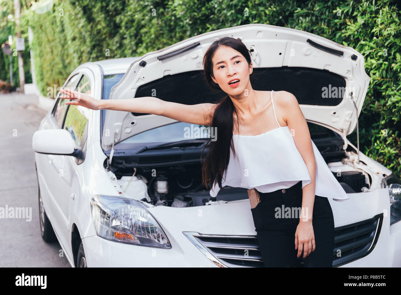 Young female hitchhiker standing roadside hi-res stock photography and images - Alamy