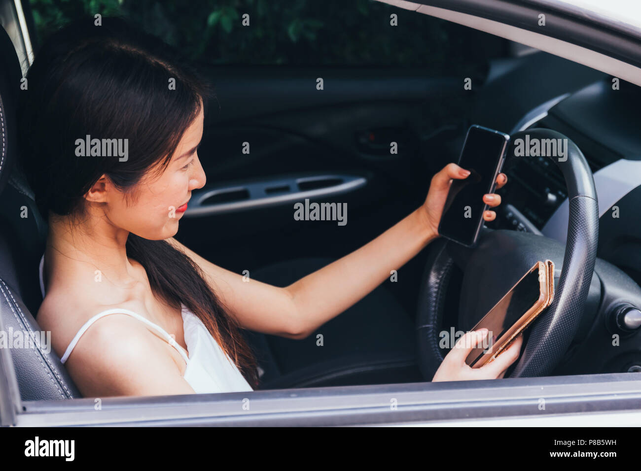 Woman multitasking while driving hi-res stock photography and images ...