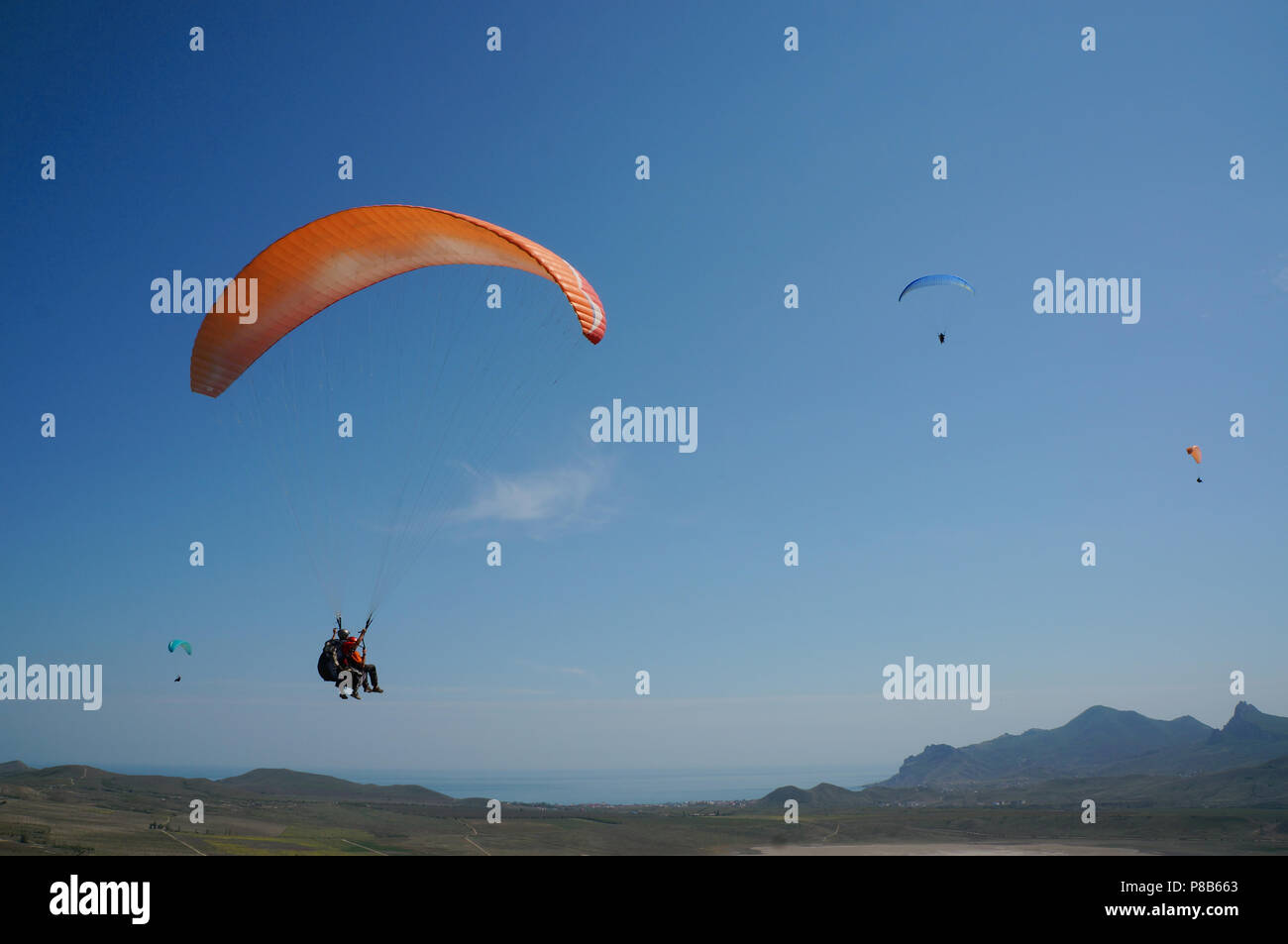 people flying on paraplanes sky with clouds on background Stock Photo ...