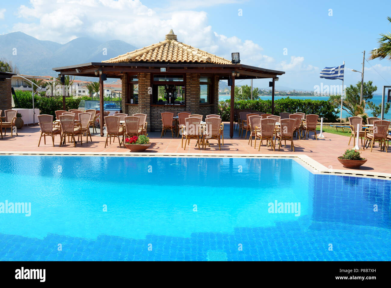 The swimming pool near bar and Greek flag, Peloponnes, Greece Stock ...