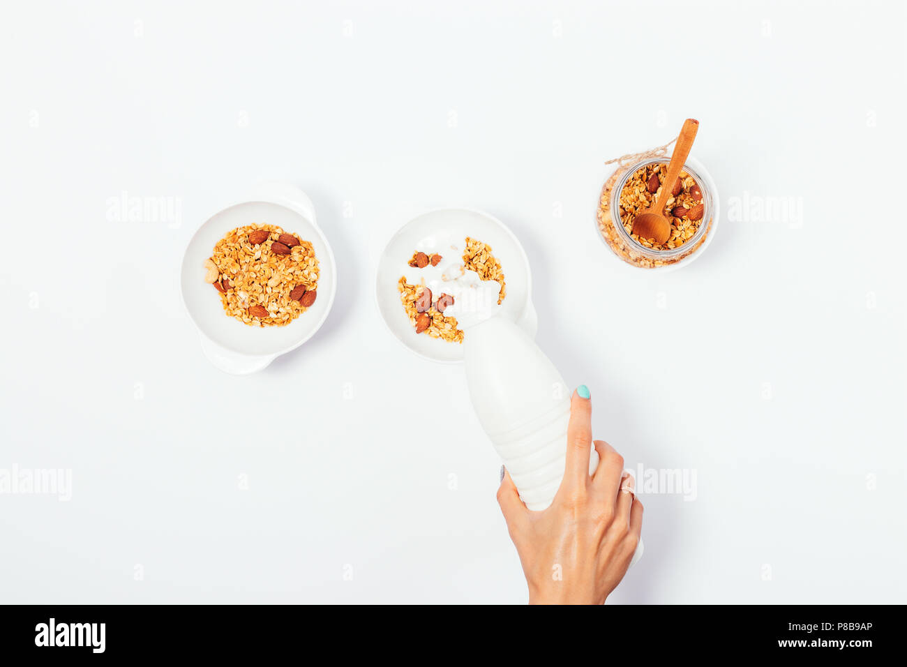 Woman doing healthy nut granola breakfast for two, top view. Female's ...