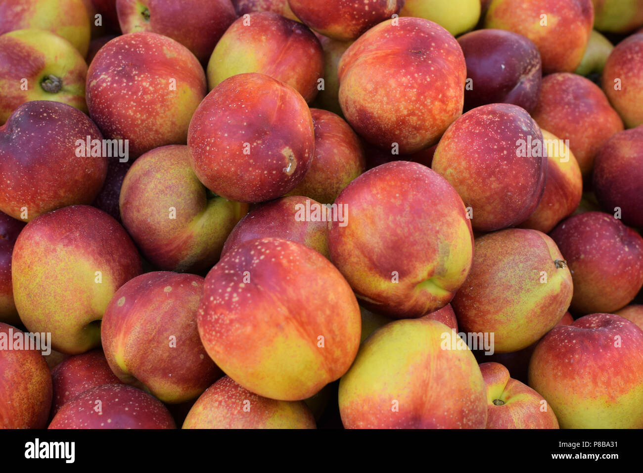 Nectarine background fuzzless peach fruit variety at grocery store ...
