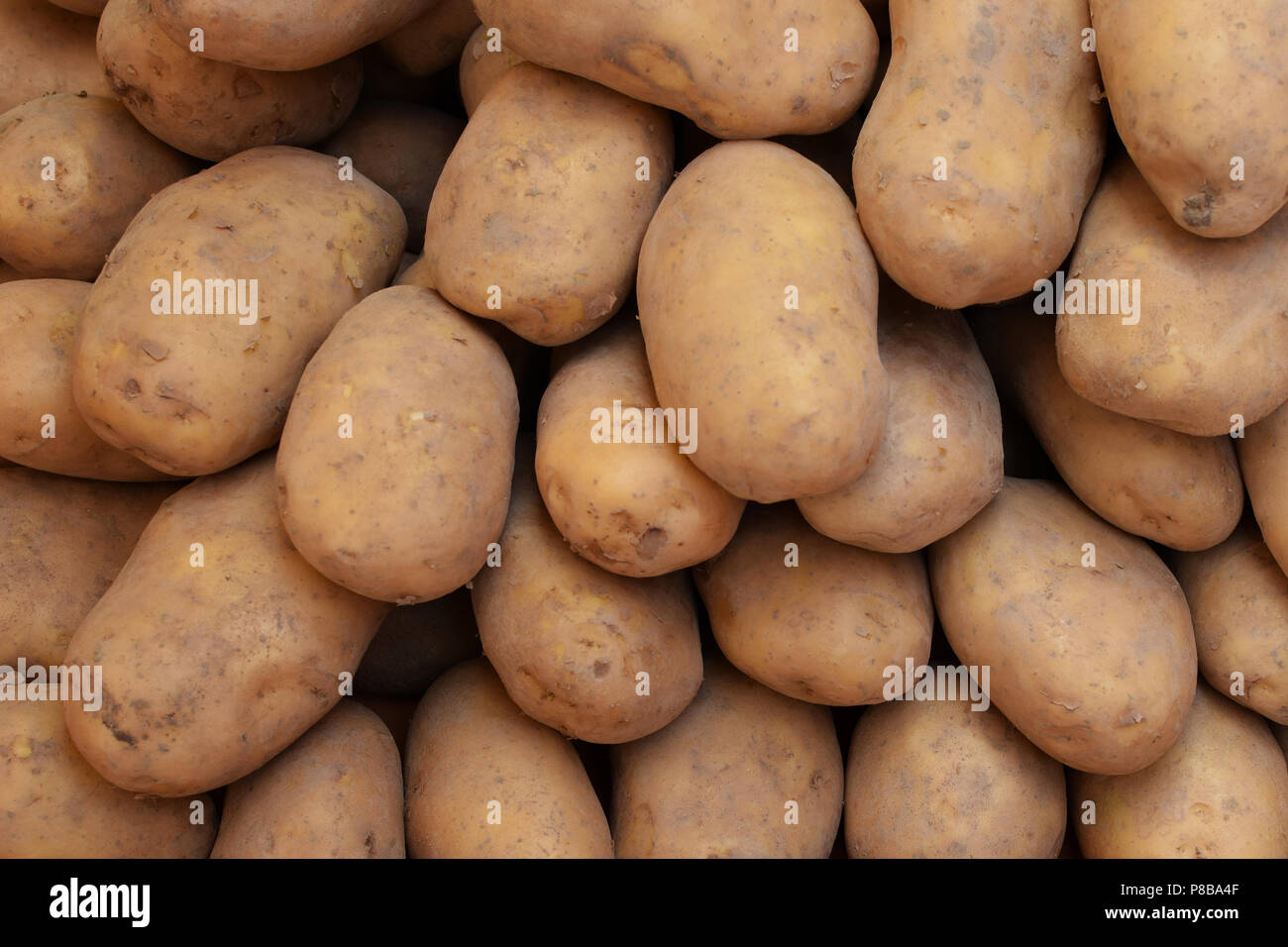Pile of potatoes with skin. Staple food background Stock Photo - Alamy