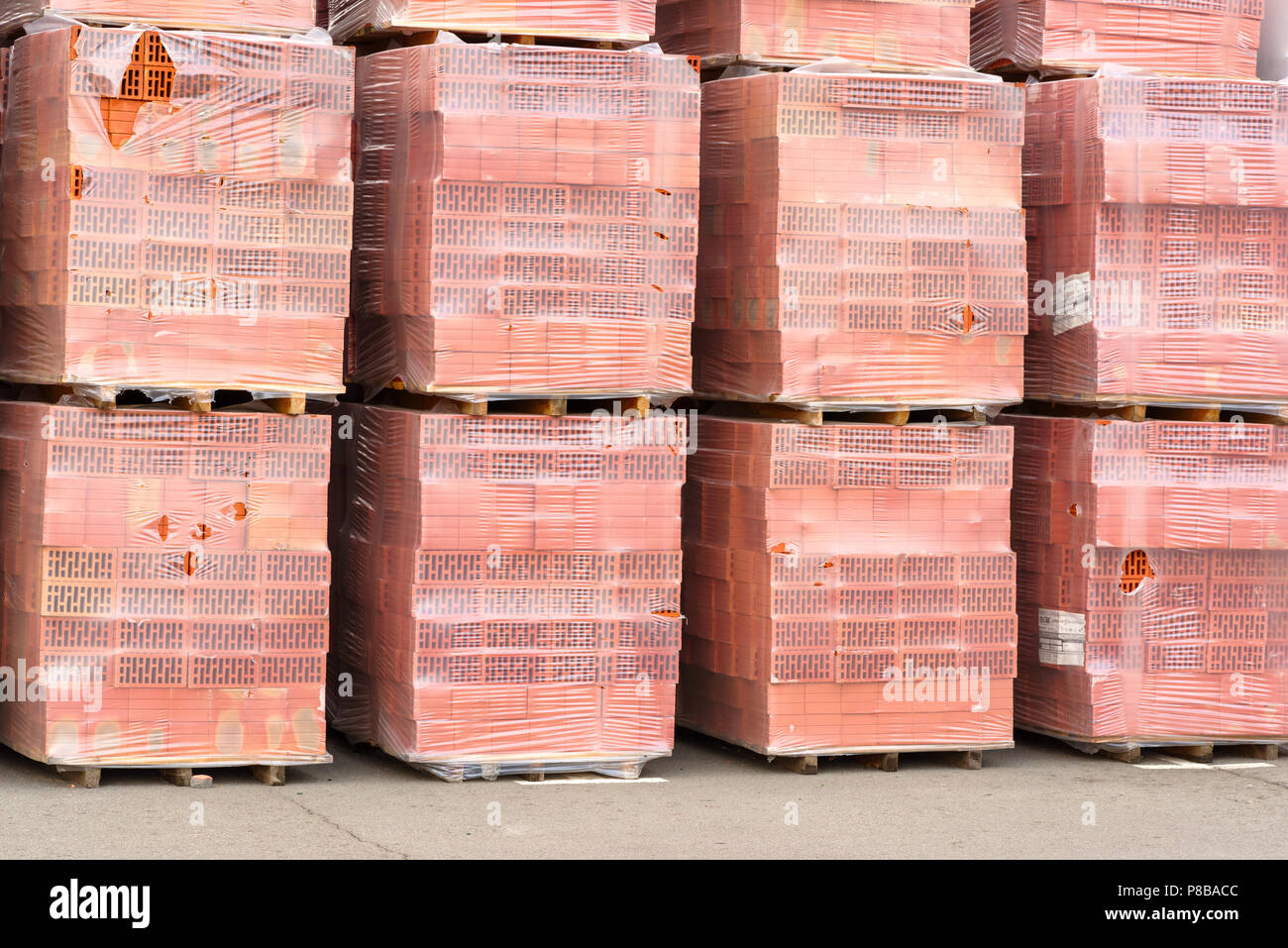 A lot of red brick for construction on pallets Stock Photo - Alamy
