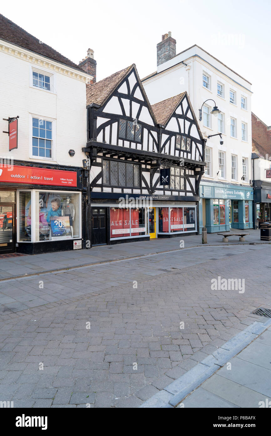 Tudor building between modern high street buildings Stock Photo - Alamy